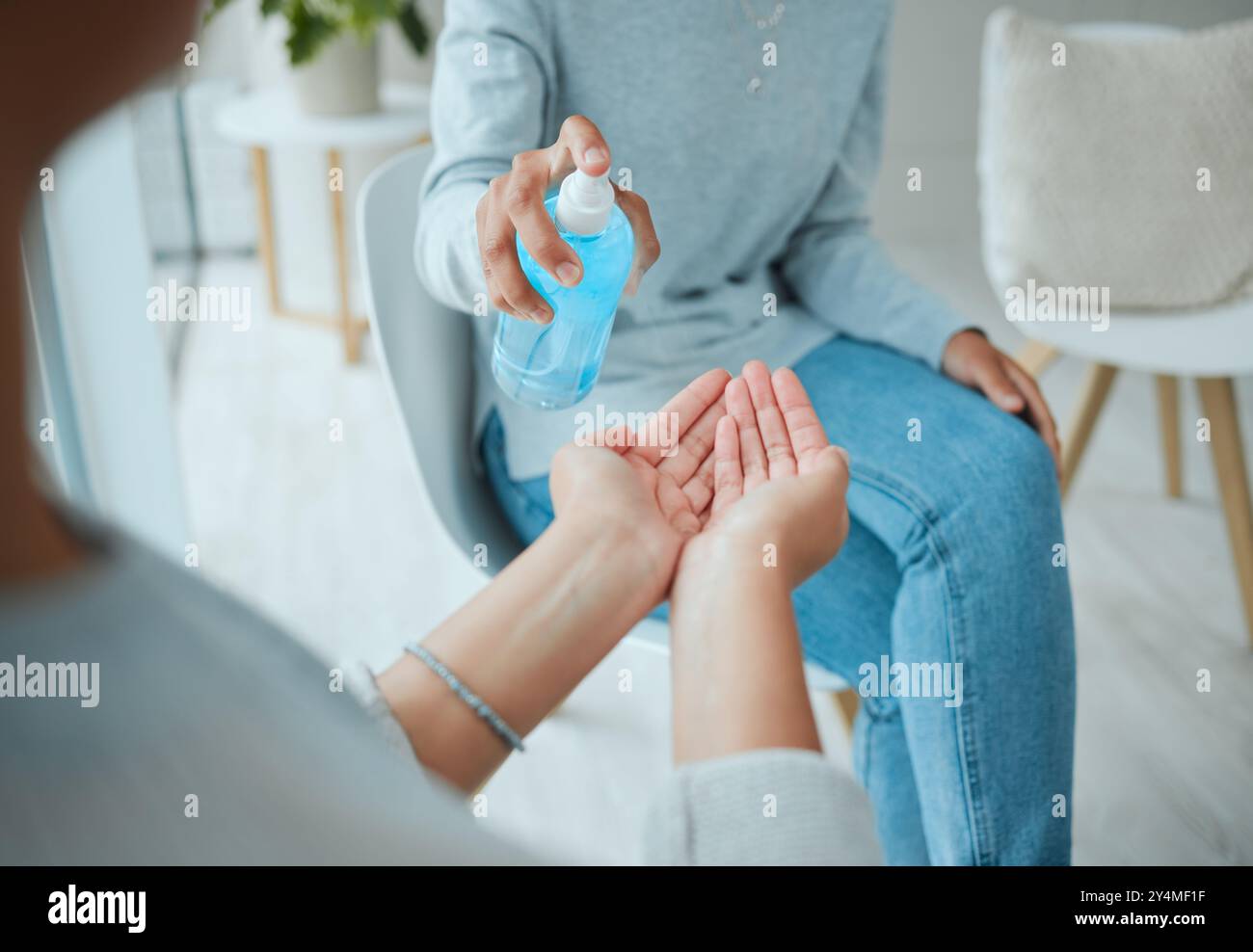 Hands, people and spray sanitiser in hospital for germs disinfection ...