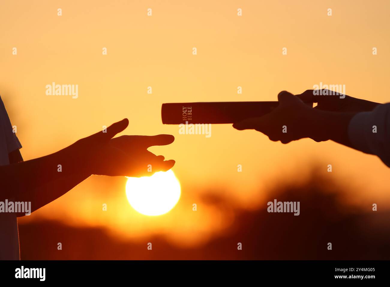 Christian giving the Holy Bible as a gift, church evangelism concept ...