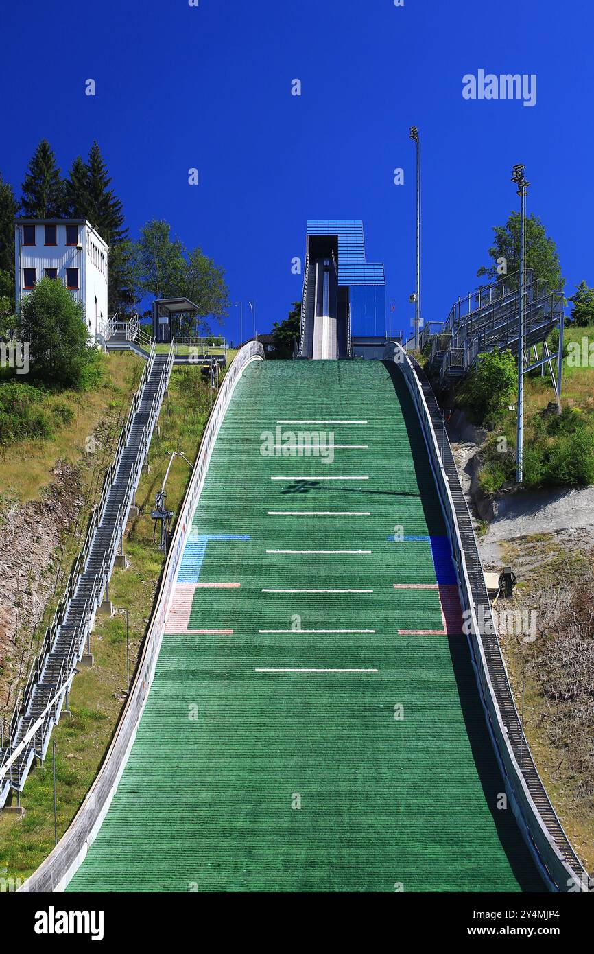 Close-up view of ski jump ramp with stairs and blue sky background in ...