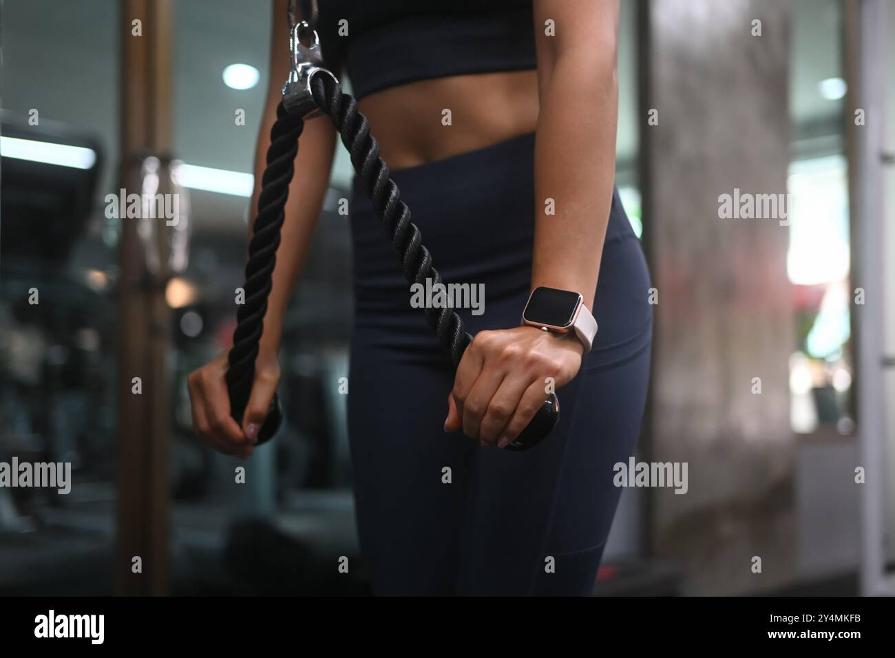 Fit young woman doing triceps rope exercise in gym Stock Photo - Alamy