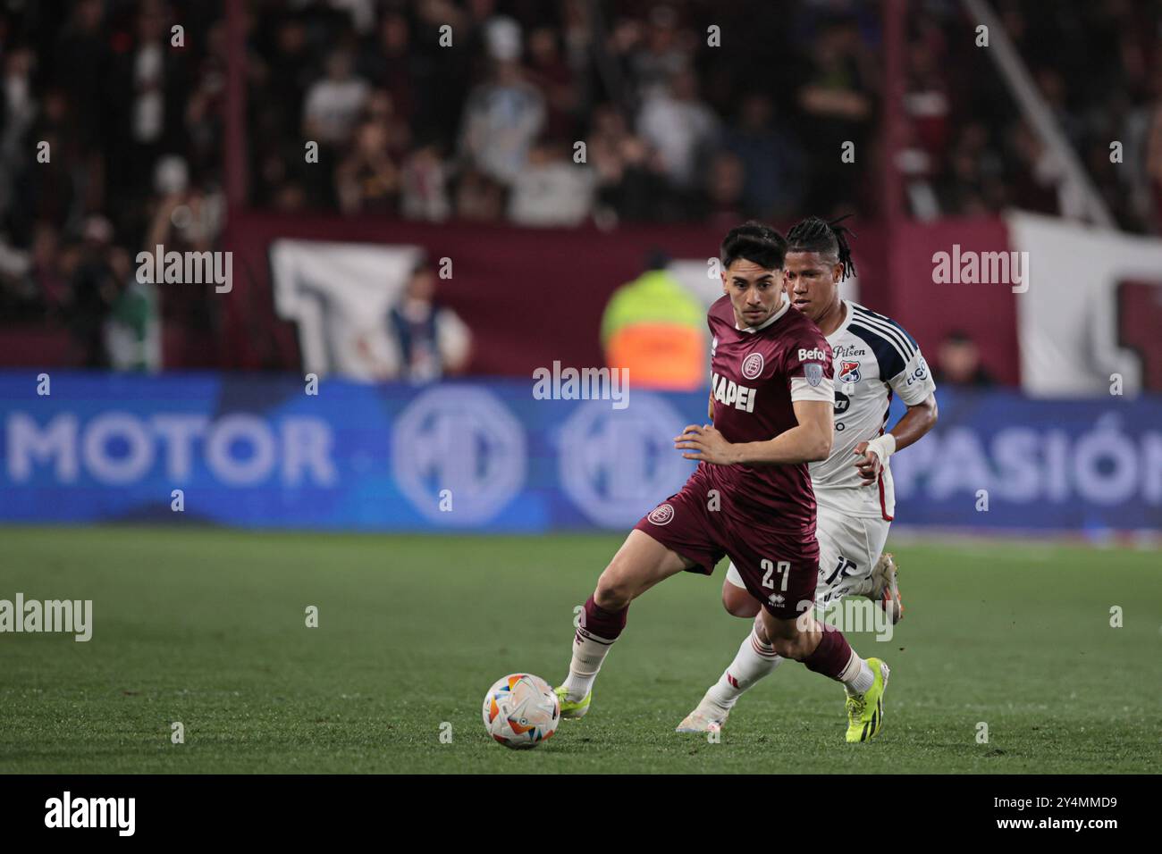 Jonathan torres From lanus (27) control a ball against Jaime Alvarado ...