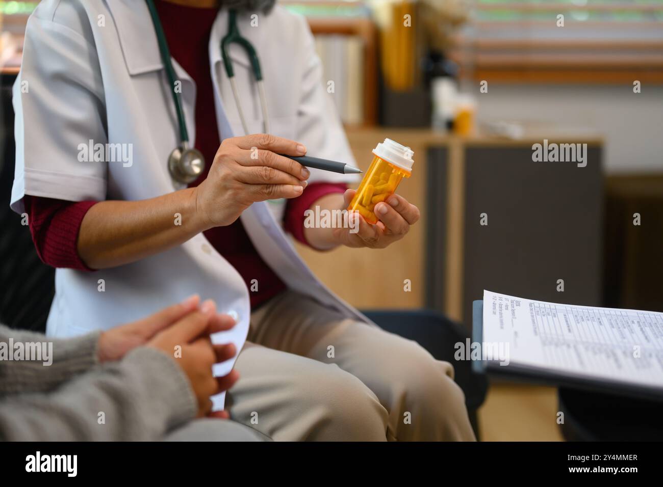 Mature female doctor giving medication instructions to patients ...