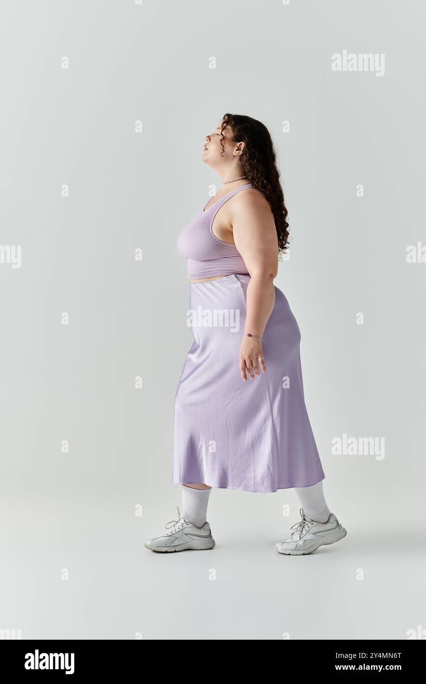 An elegant plus size woman walks with confidence, showcasing her beauty ...