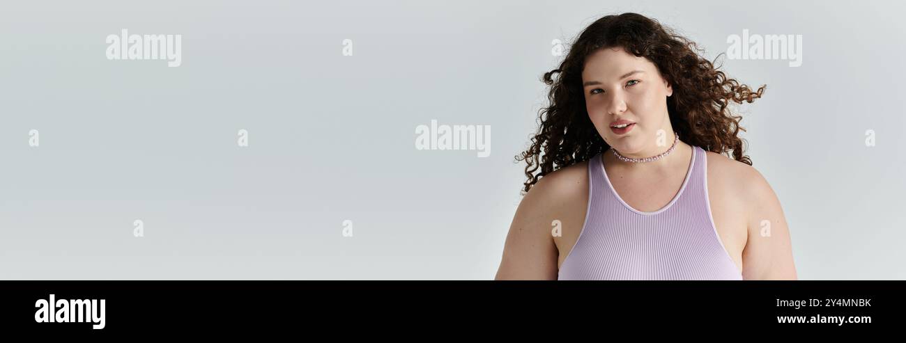 A beautiful plus size woman poses gracefully, showcasing her style and ...