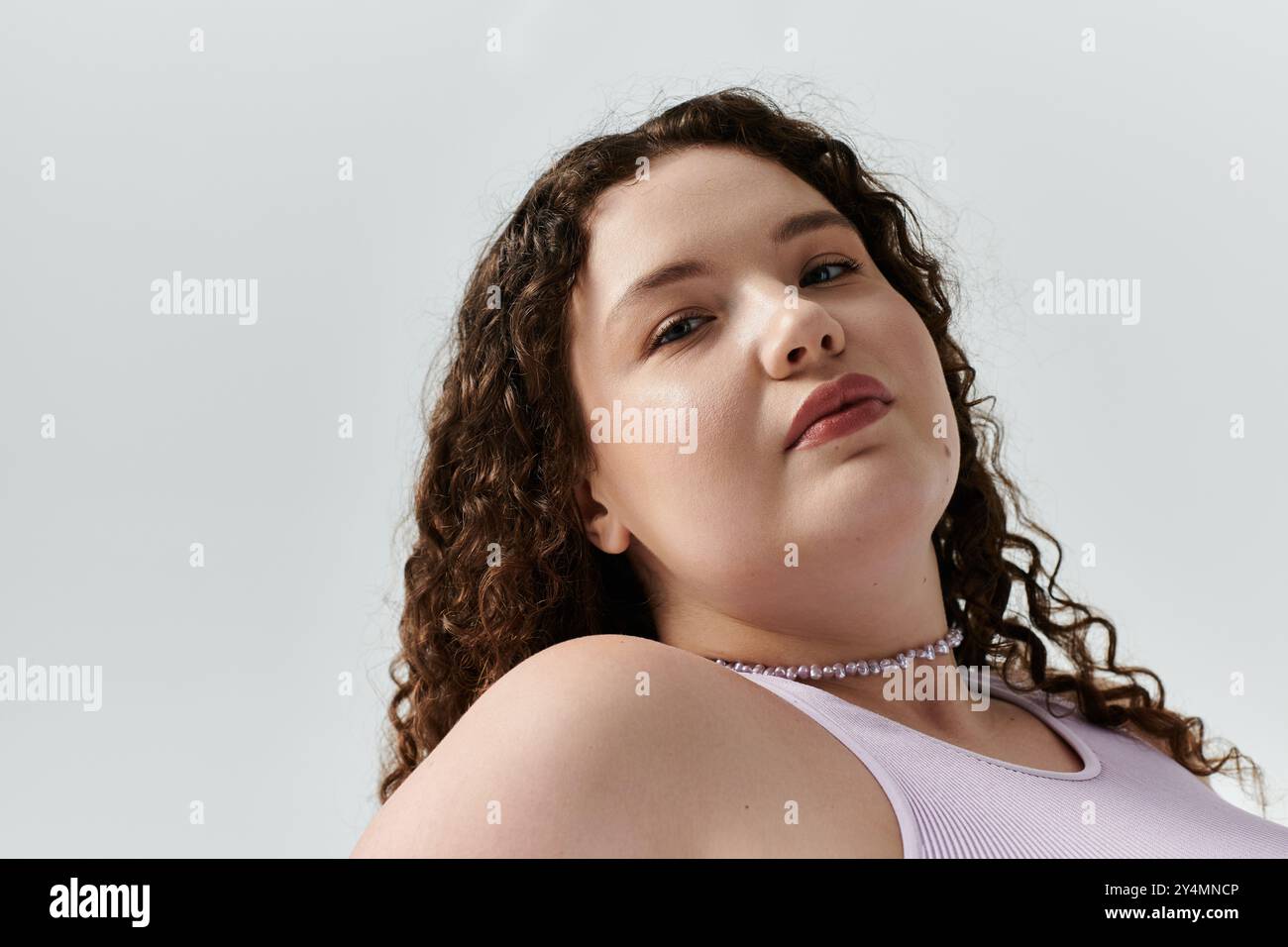 An elegant plus size woman poses confidently, showcasing beauty and ...