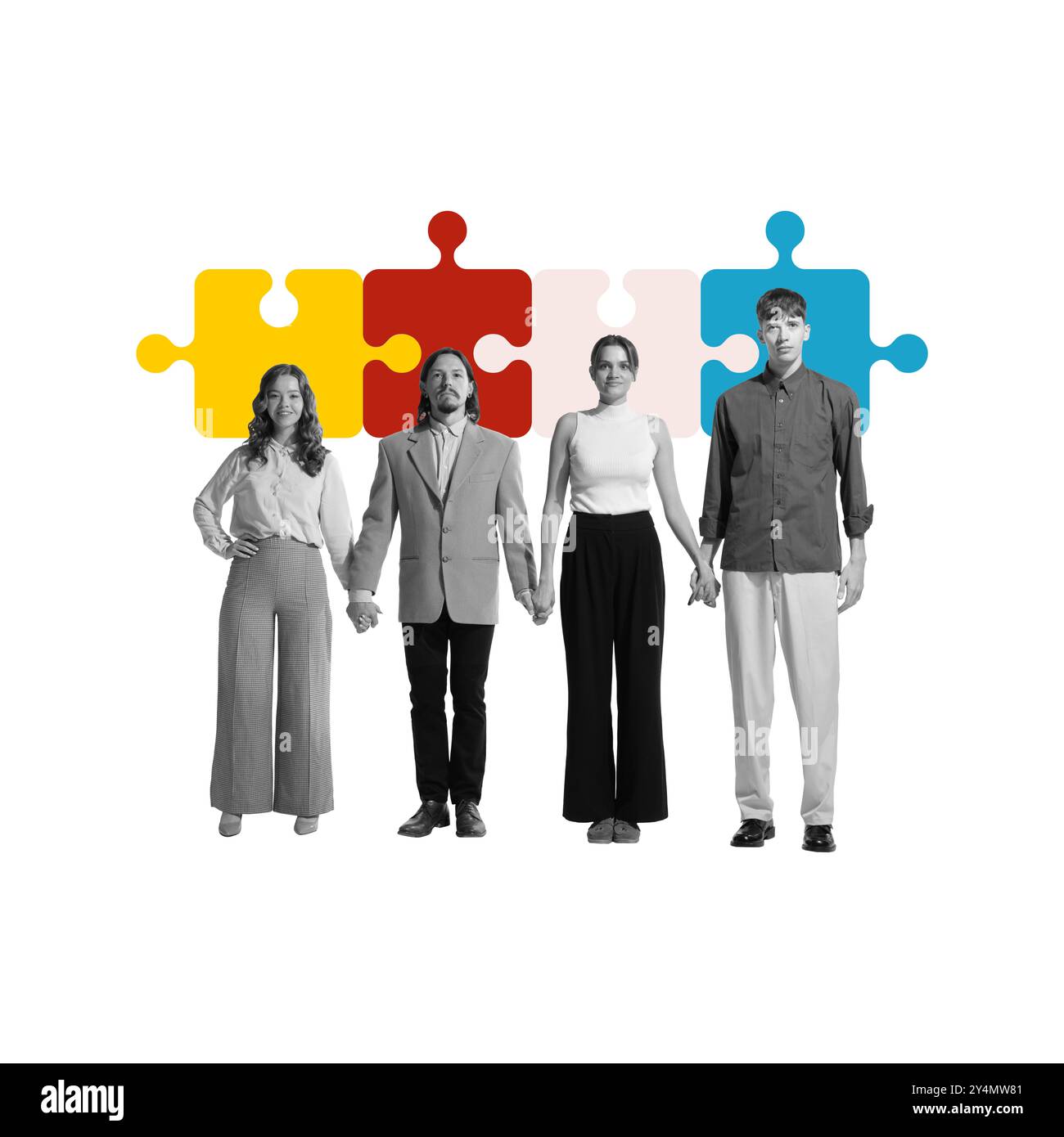 Four employees holding hands in front of puzzle pieces, symbolizing ...