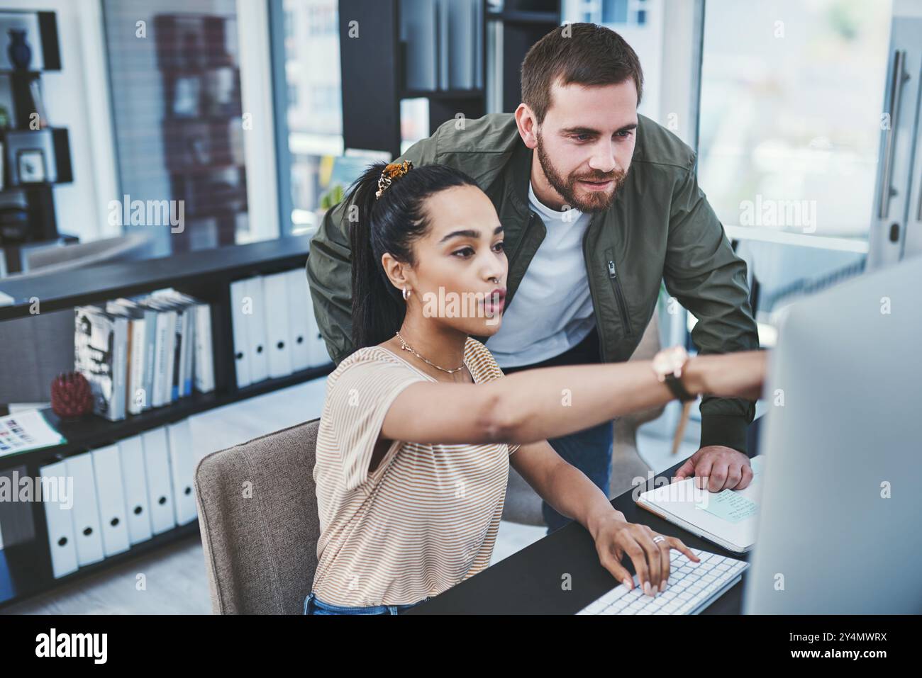 Business, people and pointing to computer in office for internship ...