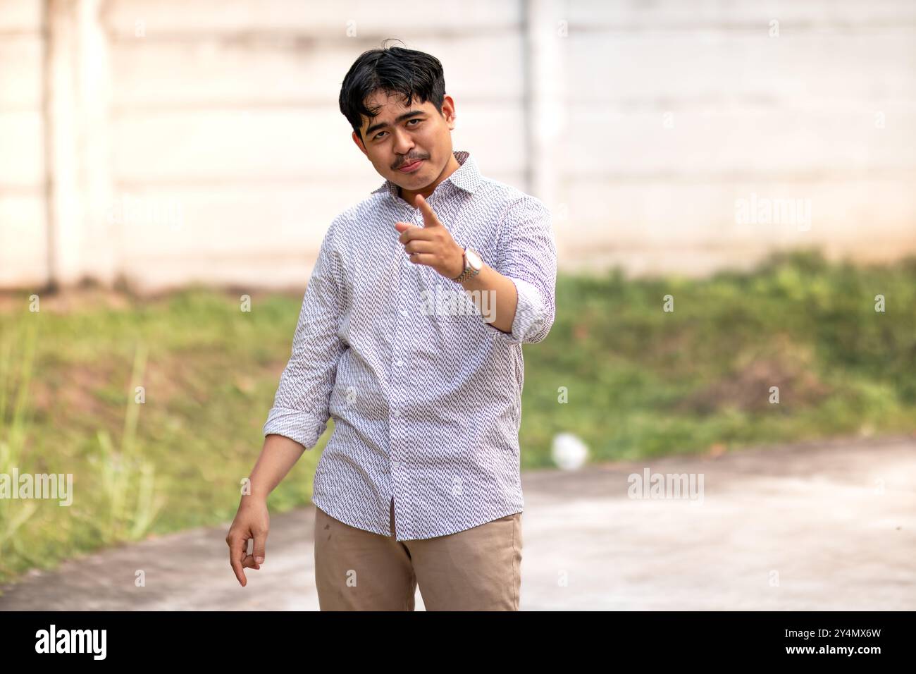 Smiling and pointing to front with finger poses. A guy smiling while ...