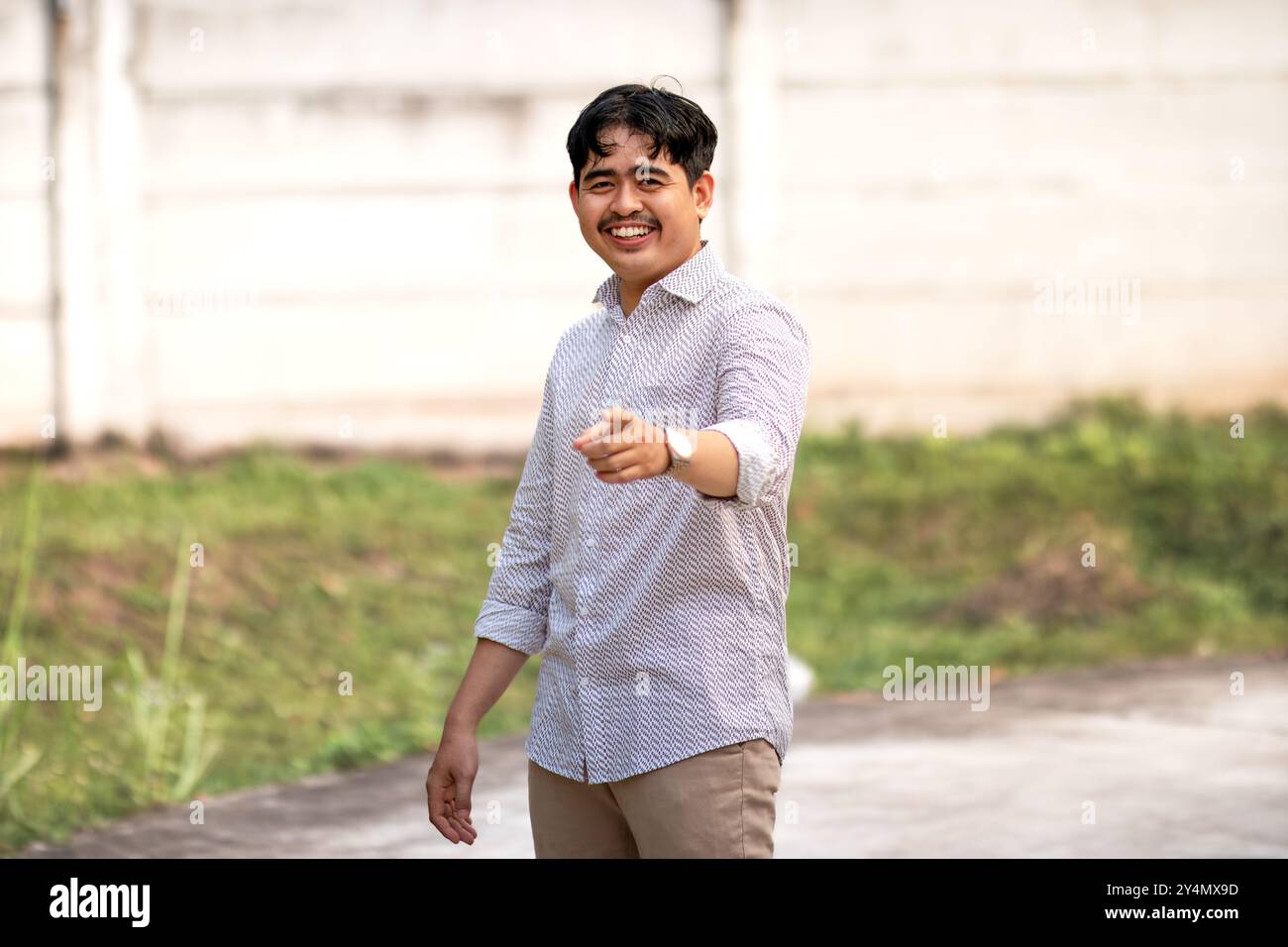 Smiling and pointing to front with finger poses. A guy smiling while ...