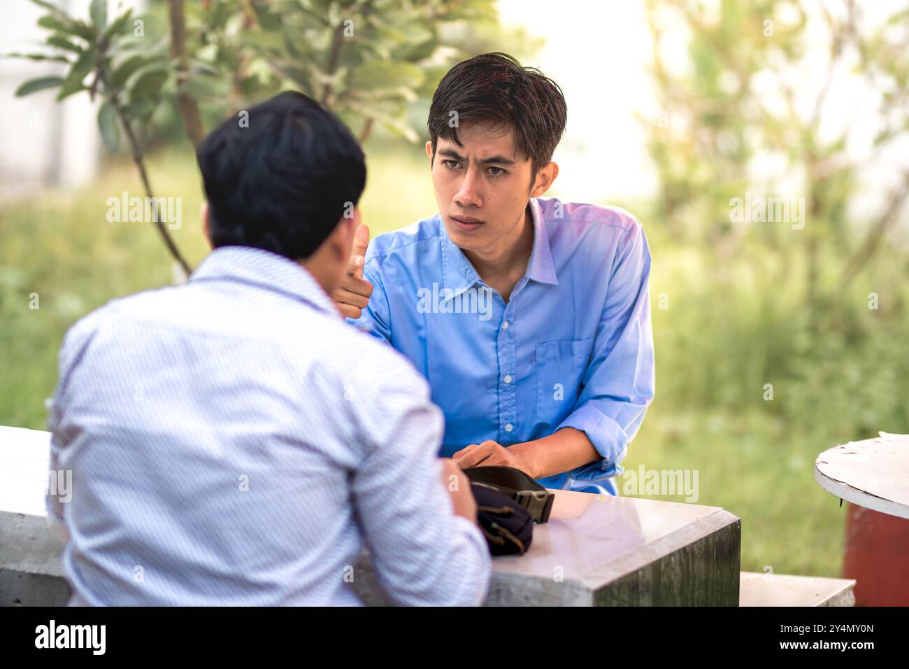 in a tense situation between men. at odds with each other. Internal ...