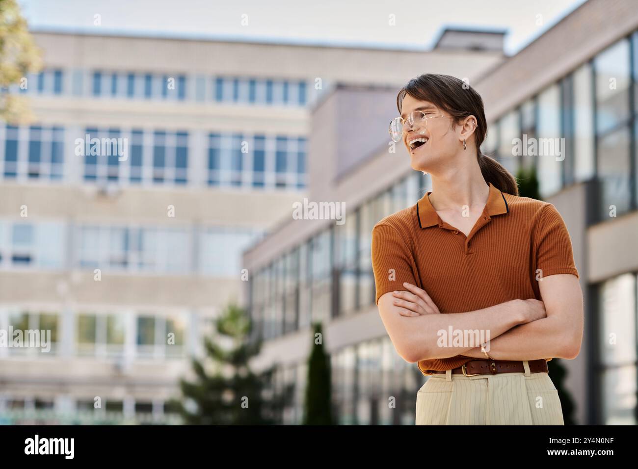 Standing confidently in the sunlight, a young non binary individual ...