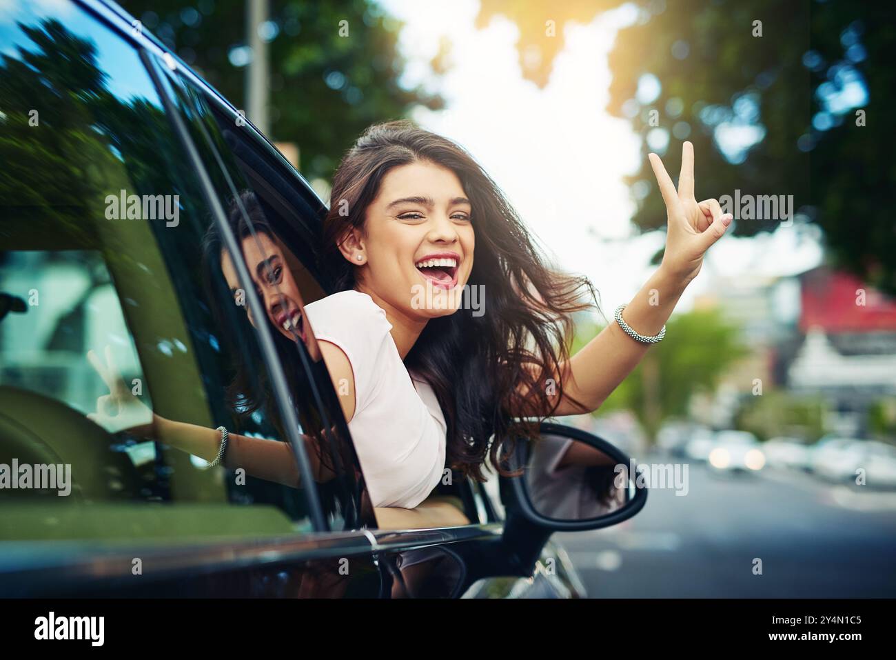 Portrait, travel and woman in car, peace sign and happy for road trip ...