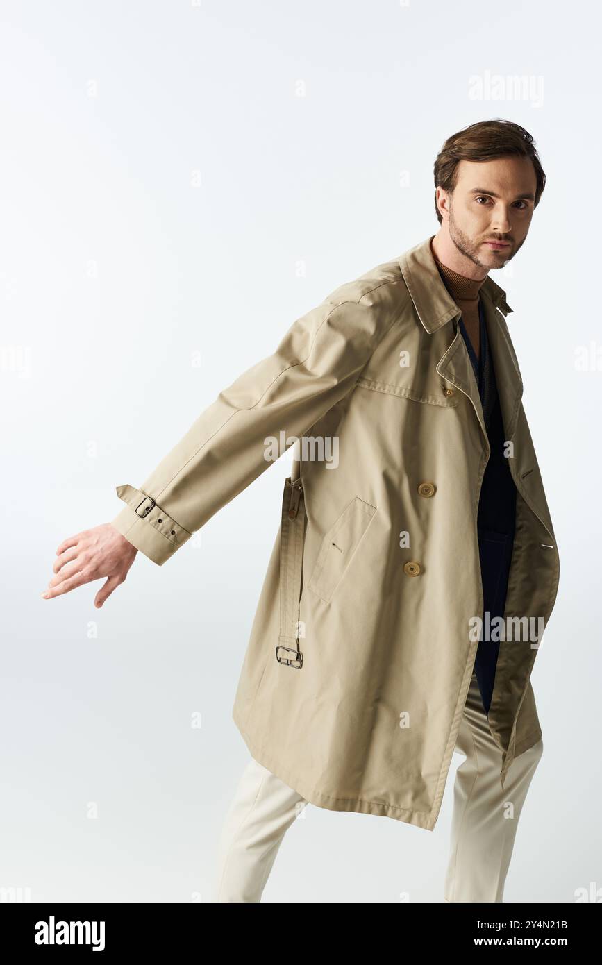 A handsome man showcasing effortless style in a light trench coat ...