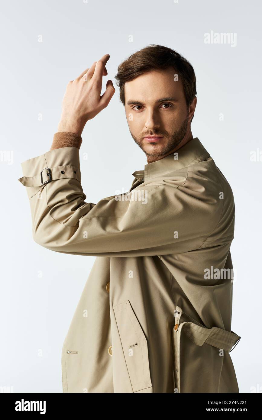 A fashionable man confidently showcases his attire, striking a pose that captures attention ...