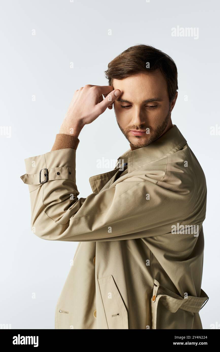 A handsome individual showcases a stylish pose, lost in thought while ...