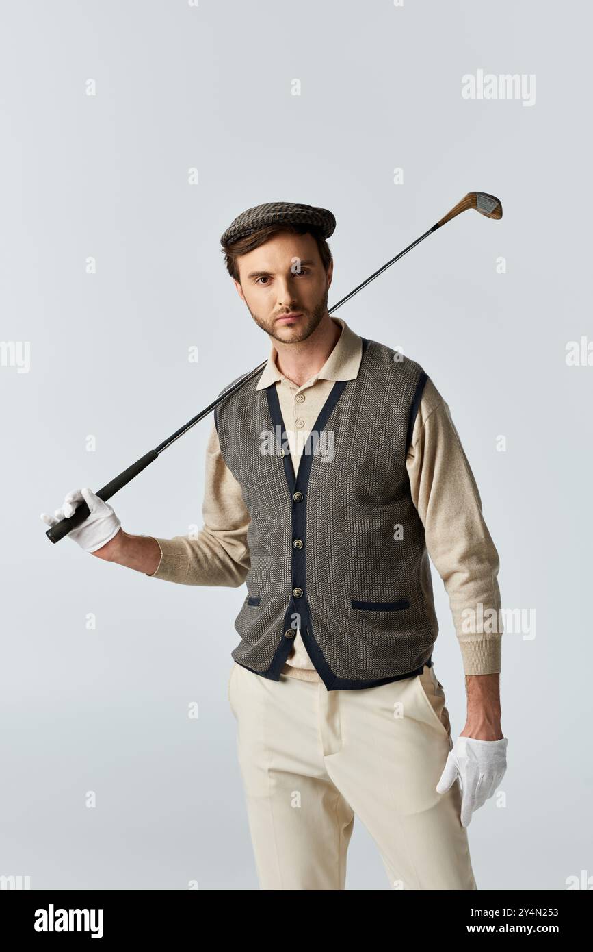 A stylish man displays confidence while holding a golf club, showcasing ...