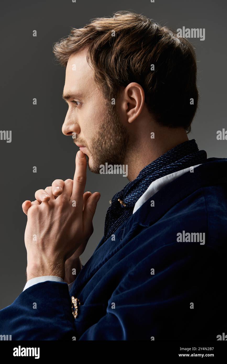 A handsome gentleman contemplates with a finger against his lips ...