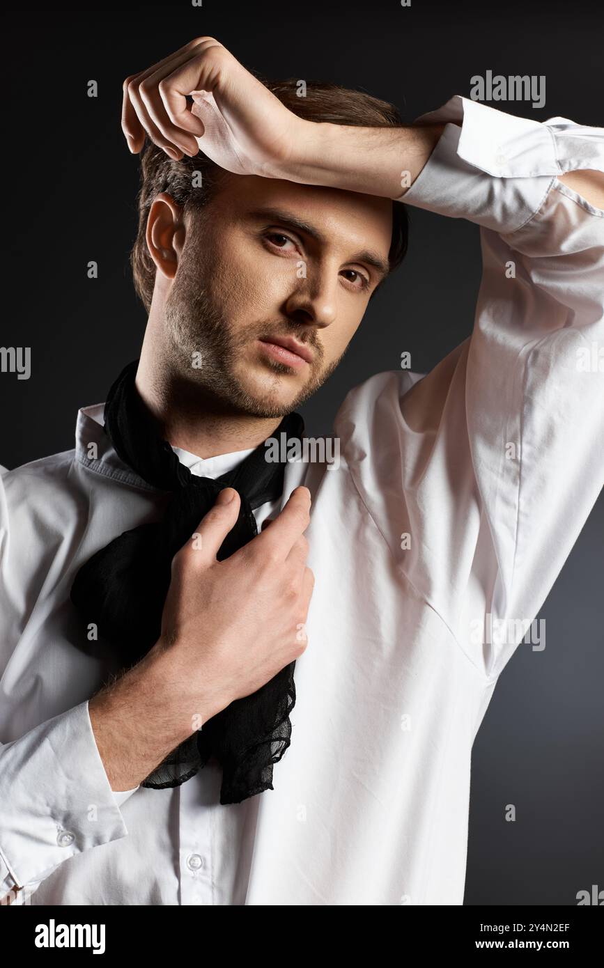 A handsome individual dressed in a classic white shirt and scarf ...