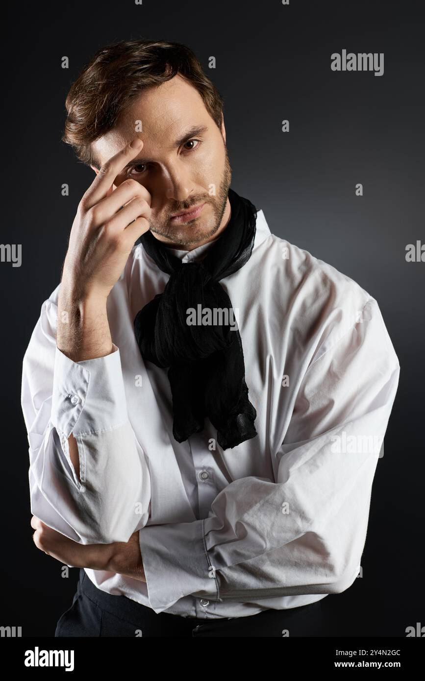 A handsome young man with a stylish dandy look reflects thoughtfully ...