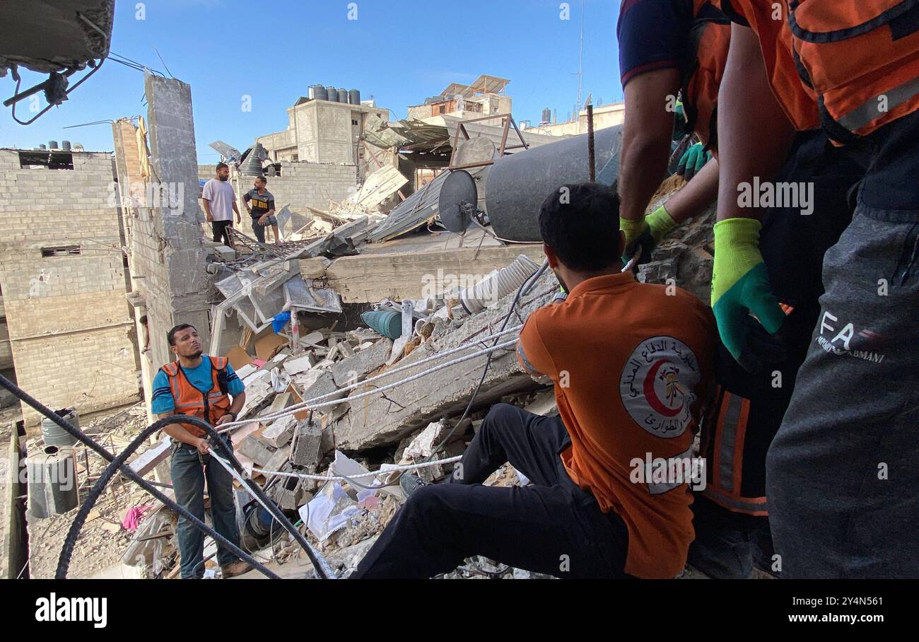 Palestinian Civil defense teams and residents carry out search and ...