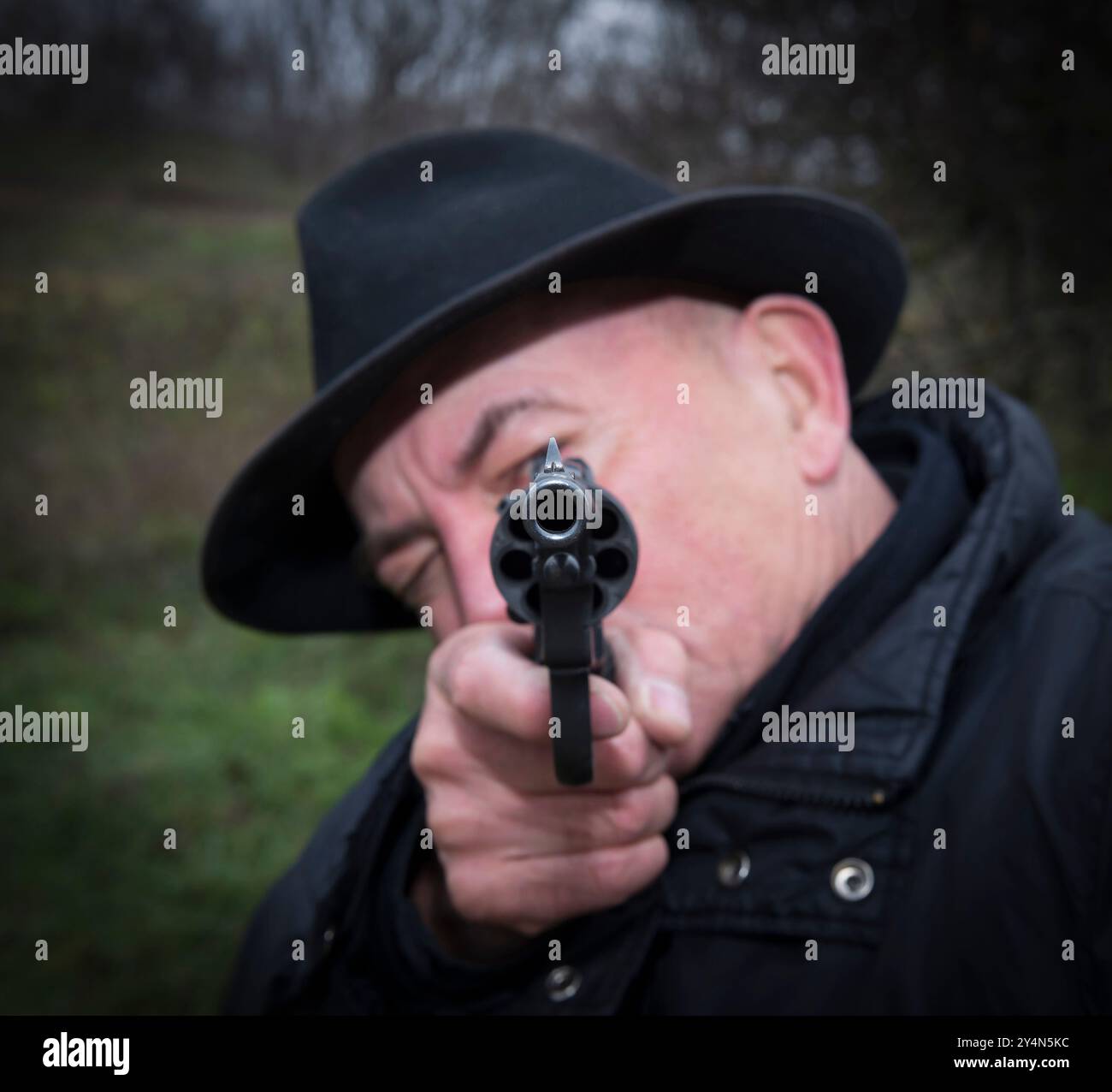 Man aiming a gun Nagan Stock Photo - Alamy