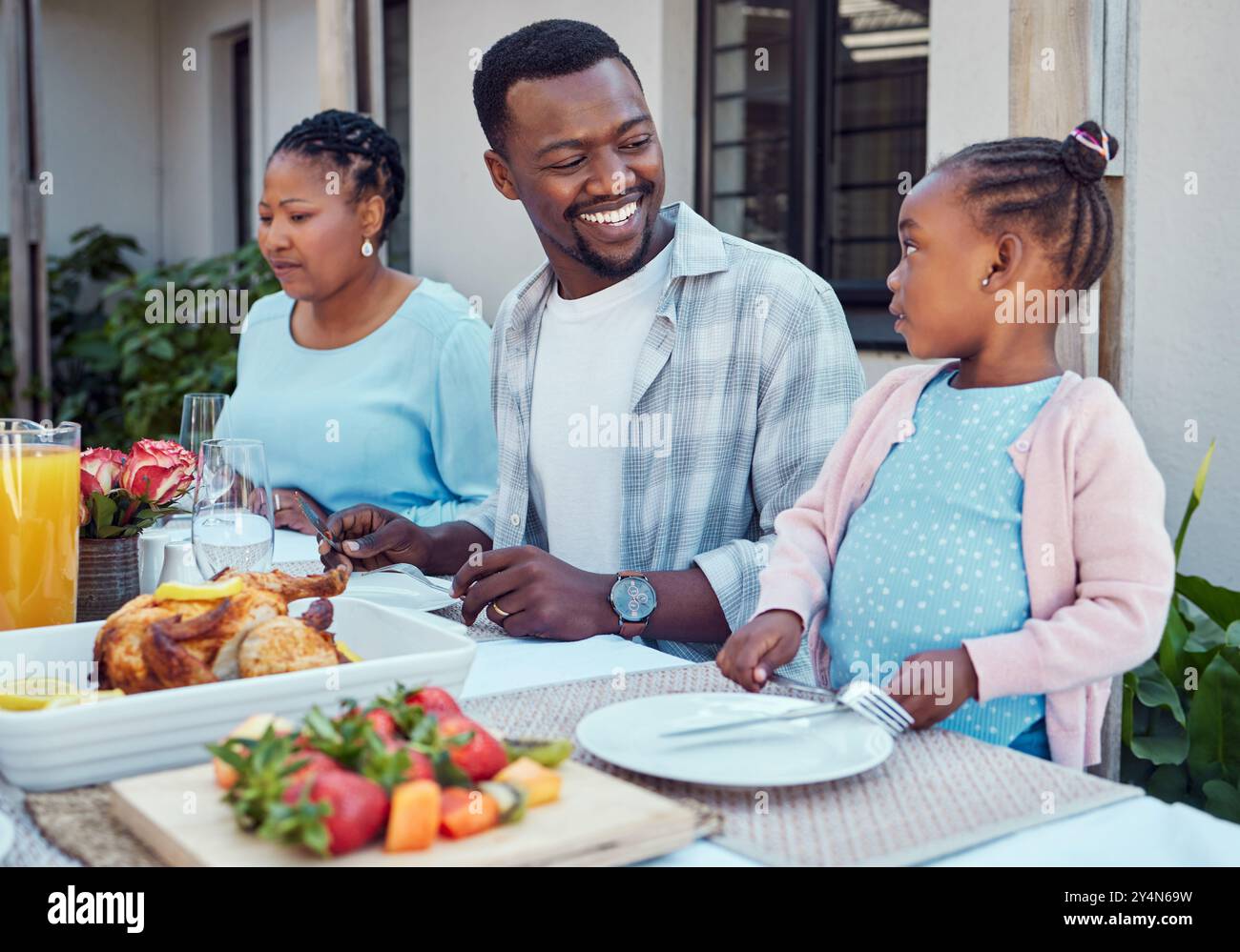 Black family, lunch and people with child by home for eating ...