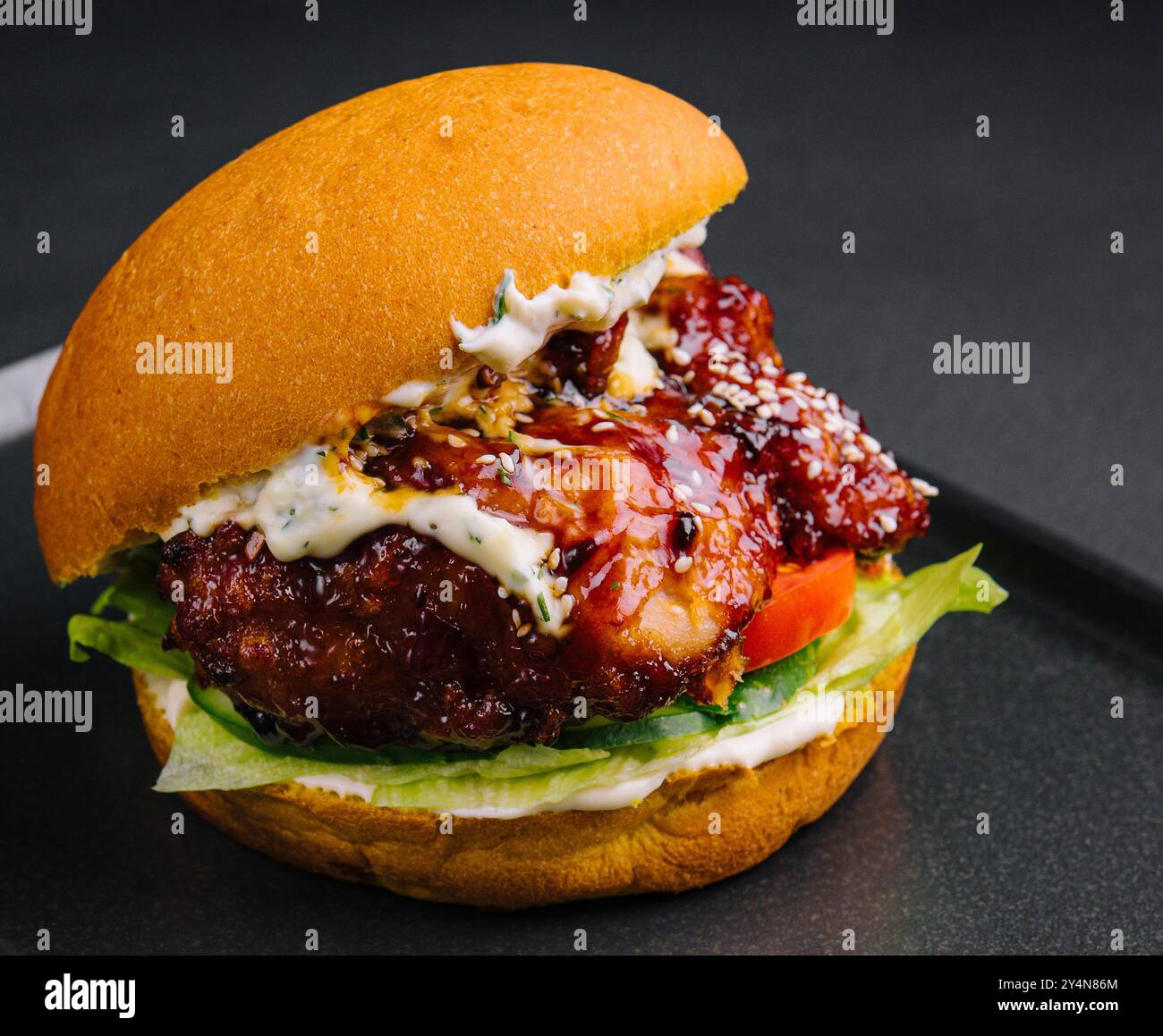 Craft burger is cooking on black tray Stock Photo - Alamy