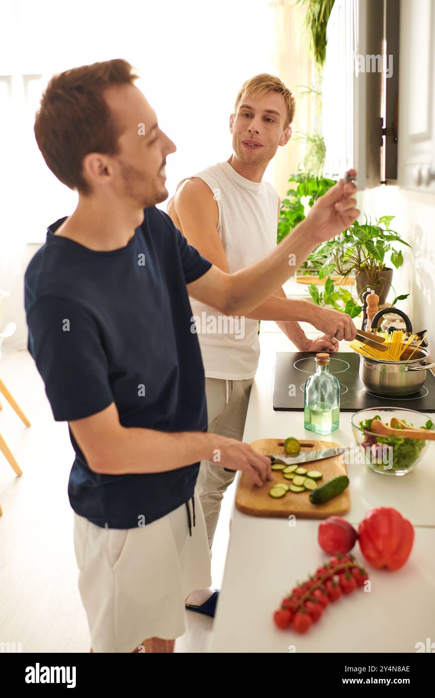Two loving partners chop fresh vegetables and cook pasta, sharing ...