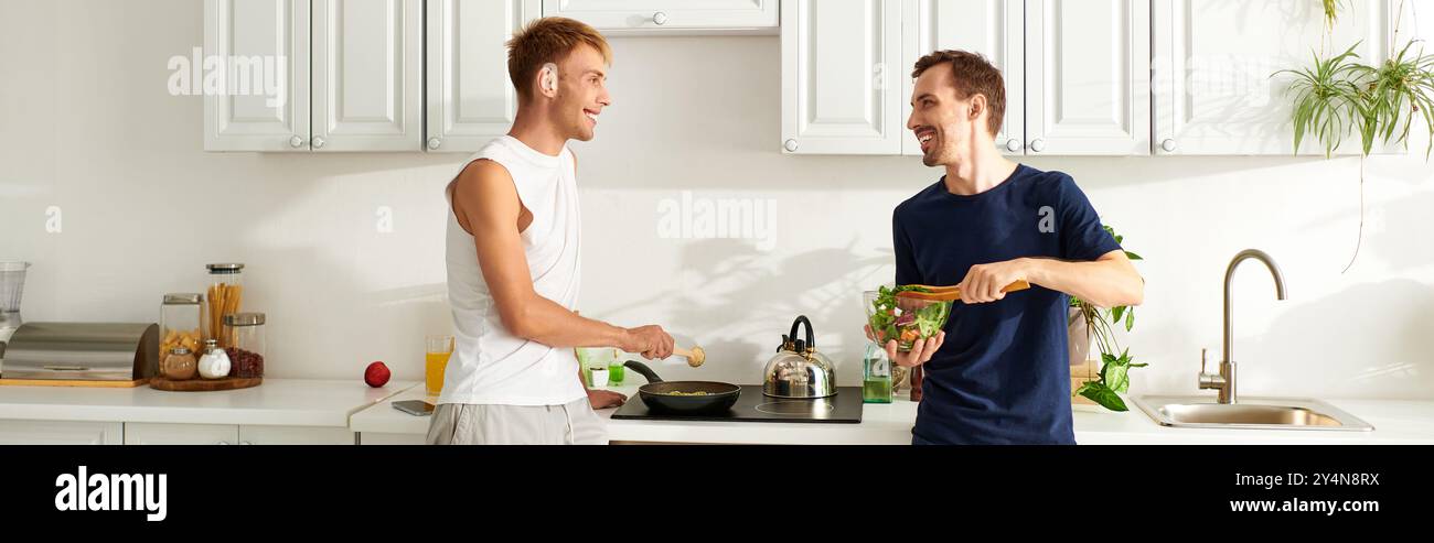 Two men happily prepare a fresh meal in their stylish kitchen, sharing ...