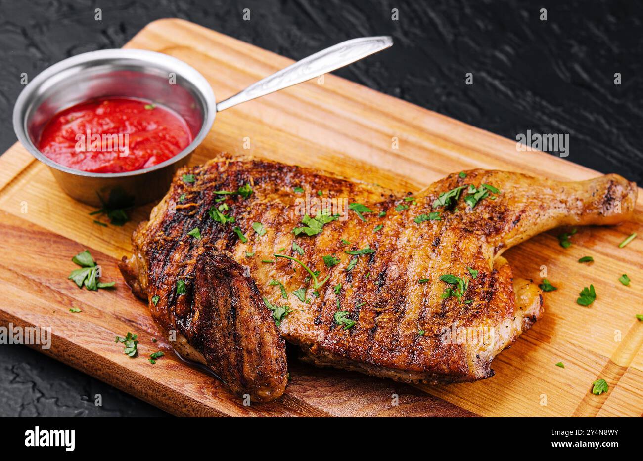 grilled bbq crispy chicken leg quarter on the wood board Stock Photo ...