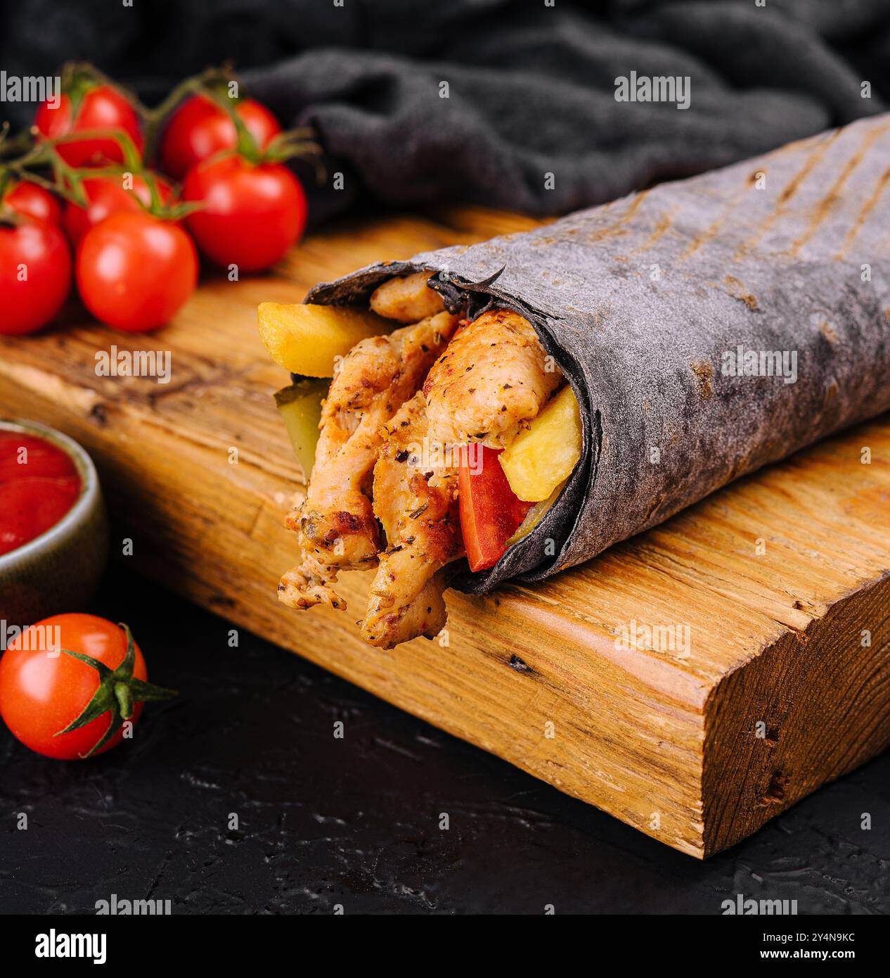 black lavash with chicken on black board Stock Photo - Alamy
