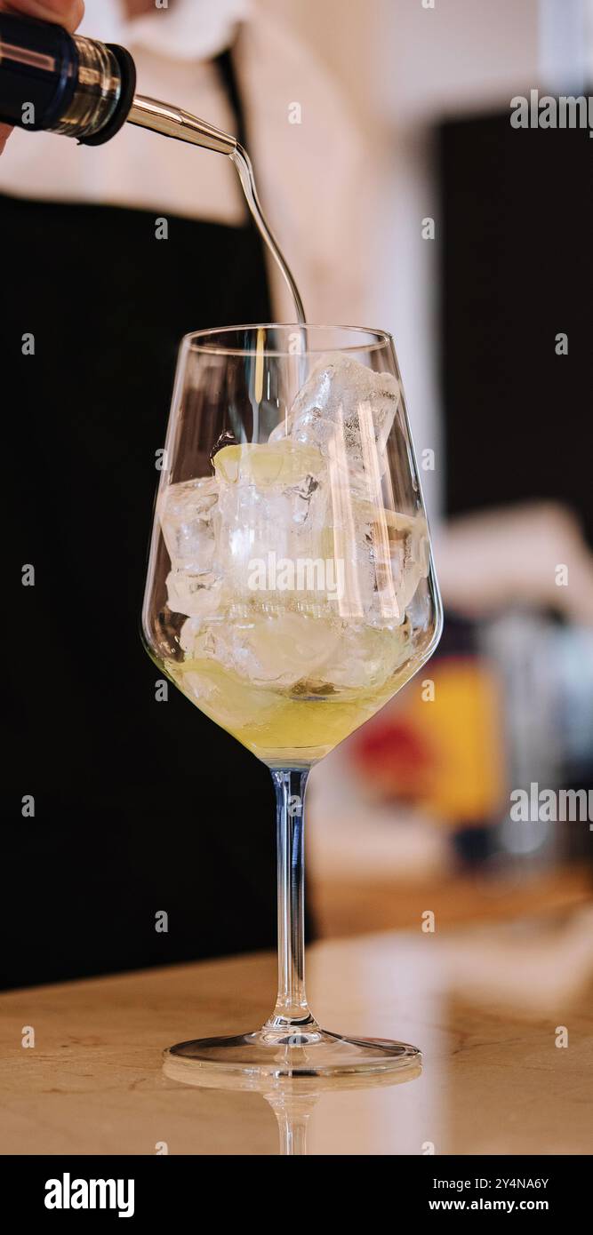 bartender pours alcohol into a glass Stock Photo - Alamy