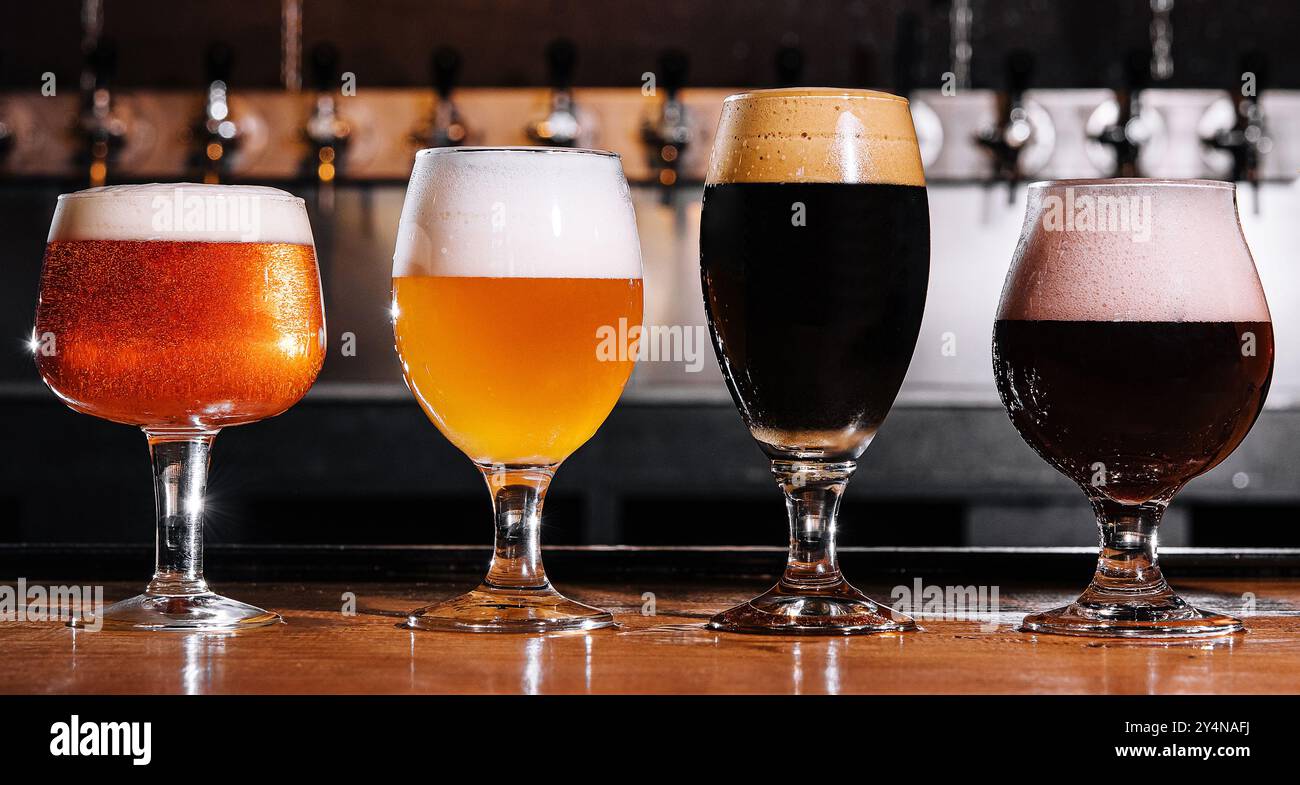 different types of craft beer in glasses on table in pub interior Stock ...