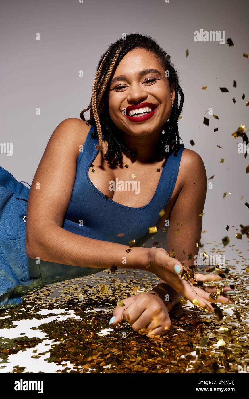 A confident young woman with vibrant braids and bold lipstick is ...