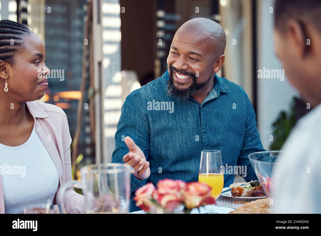 Black family, lunch and people with conversation by home for love ...