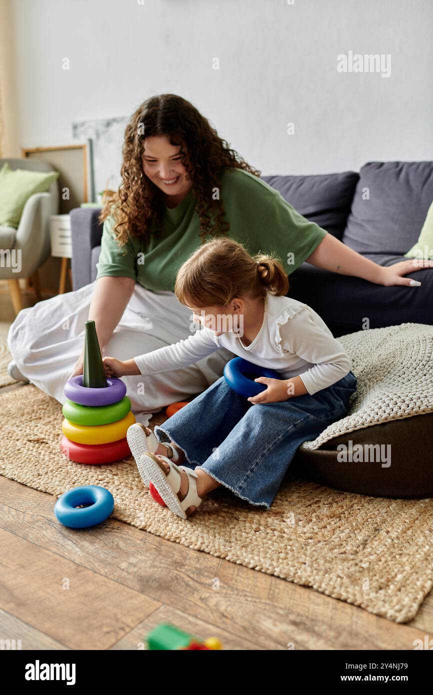 A mother enjoys quality time with her daughter, building a colorful ...