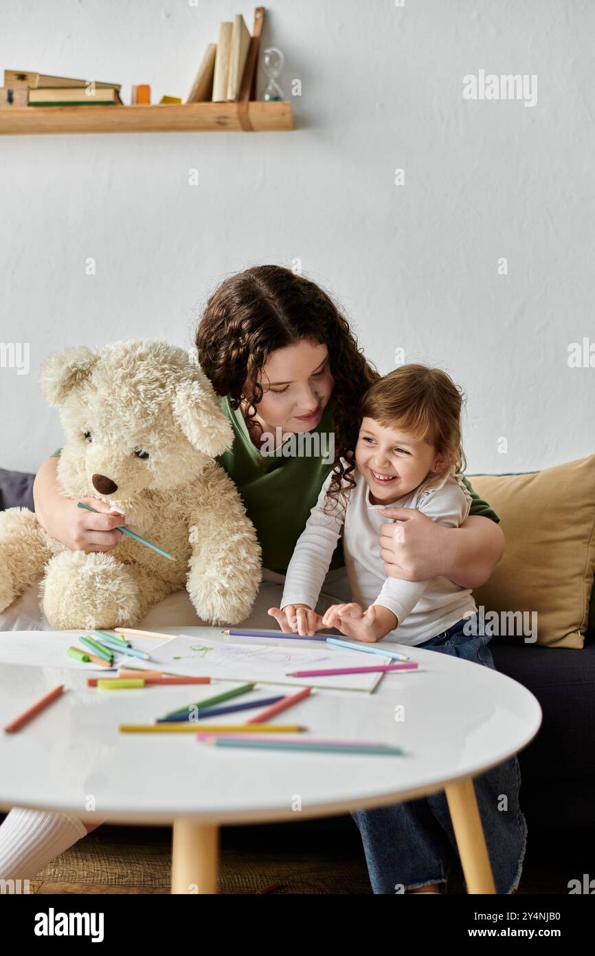A cheerful mother and her daughter enjoy an arts and crafts session ...
