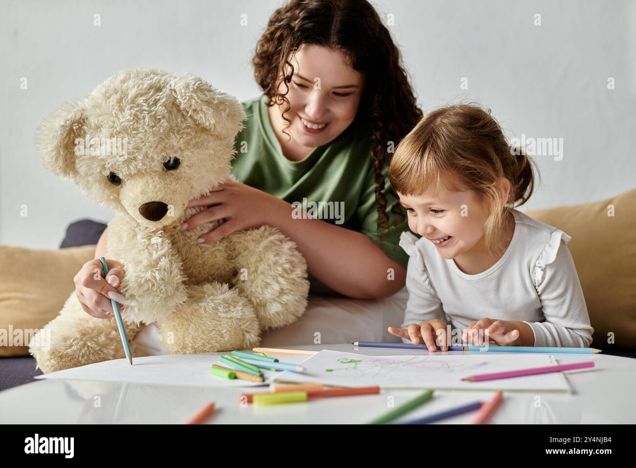 A delighted mother and her daughter engage in a joyful drawing session ...