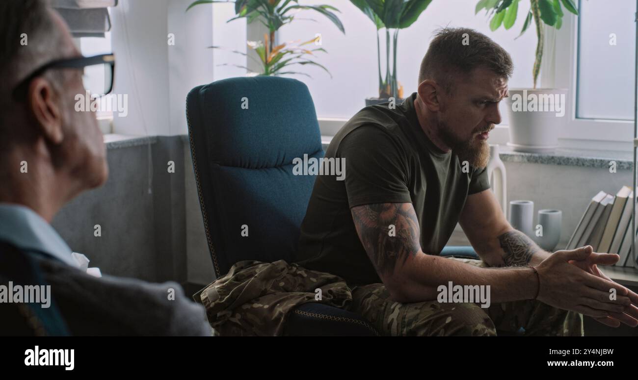 Depressed military man with PTSD sits in chair, cries and experiences ...