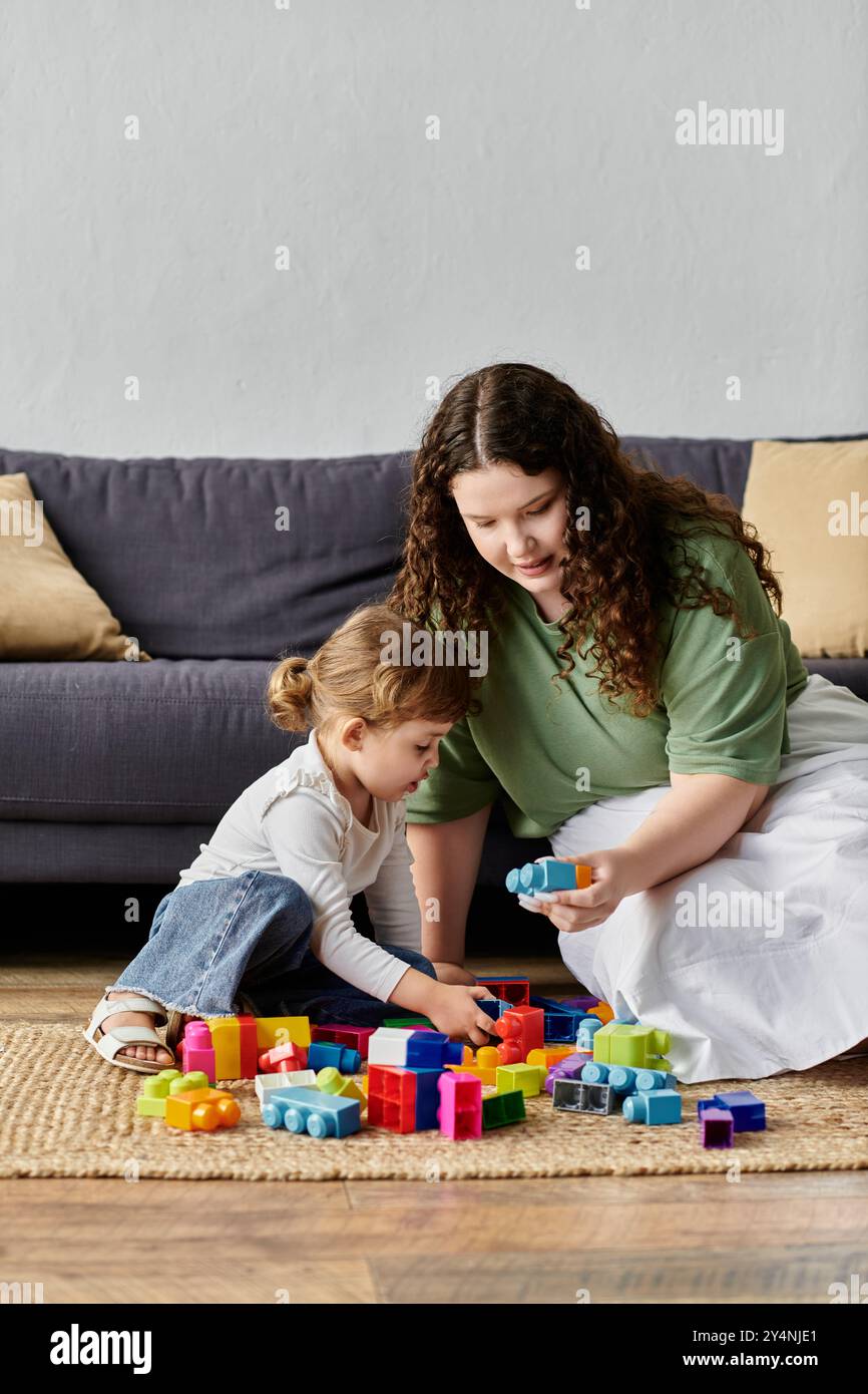 A mother and daughter create colorful block structures while enjoying ...