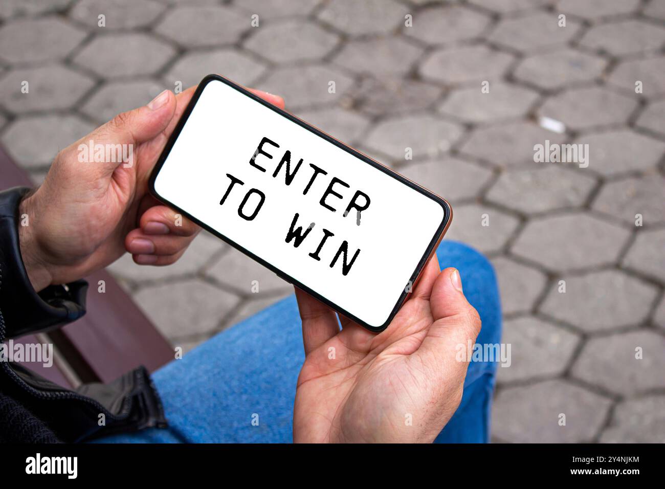 Enter to win message written on smartphone screen. Conceptual enter to ...