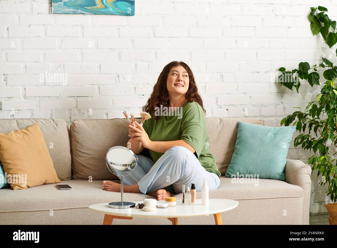 A young plus size woman relaxes while applying makeup using various ...