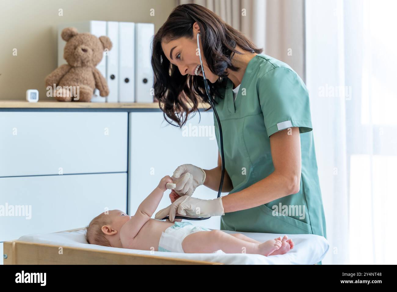 Medical professional doctor examines newborn during scheduled ...
