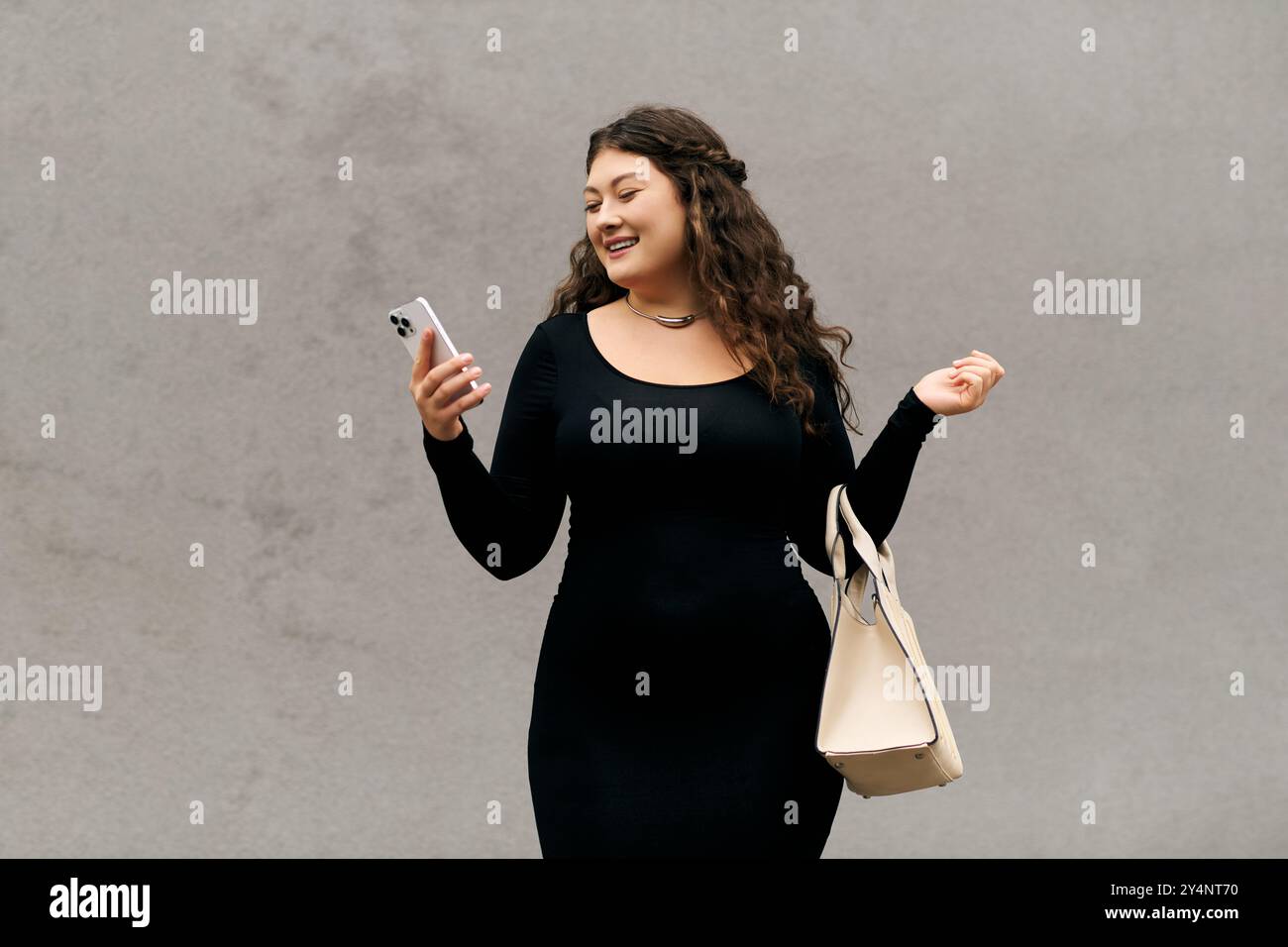 A young plus size woman gracefully walks outdoors on a crisp autumn day ...