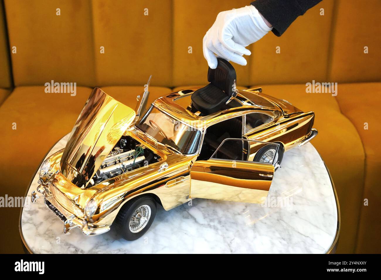 The ejector seat on a 24-carat gold-plated model of James Bond's ...