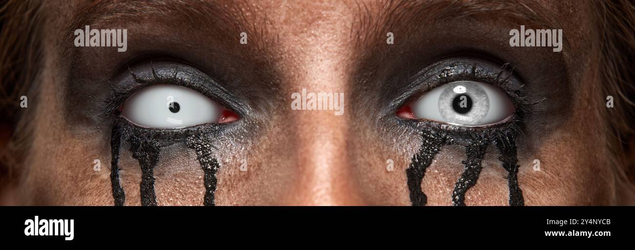 Black void-like eyes with smeared makeup dripping down the face, giving ...