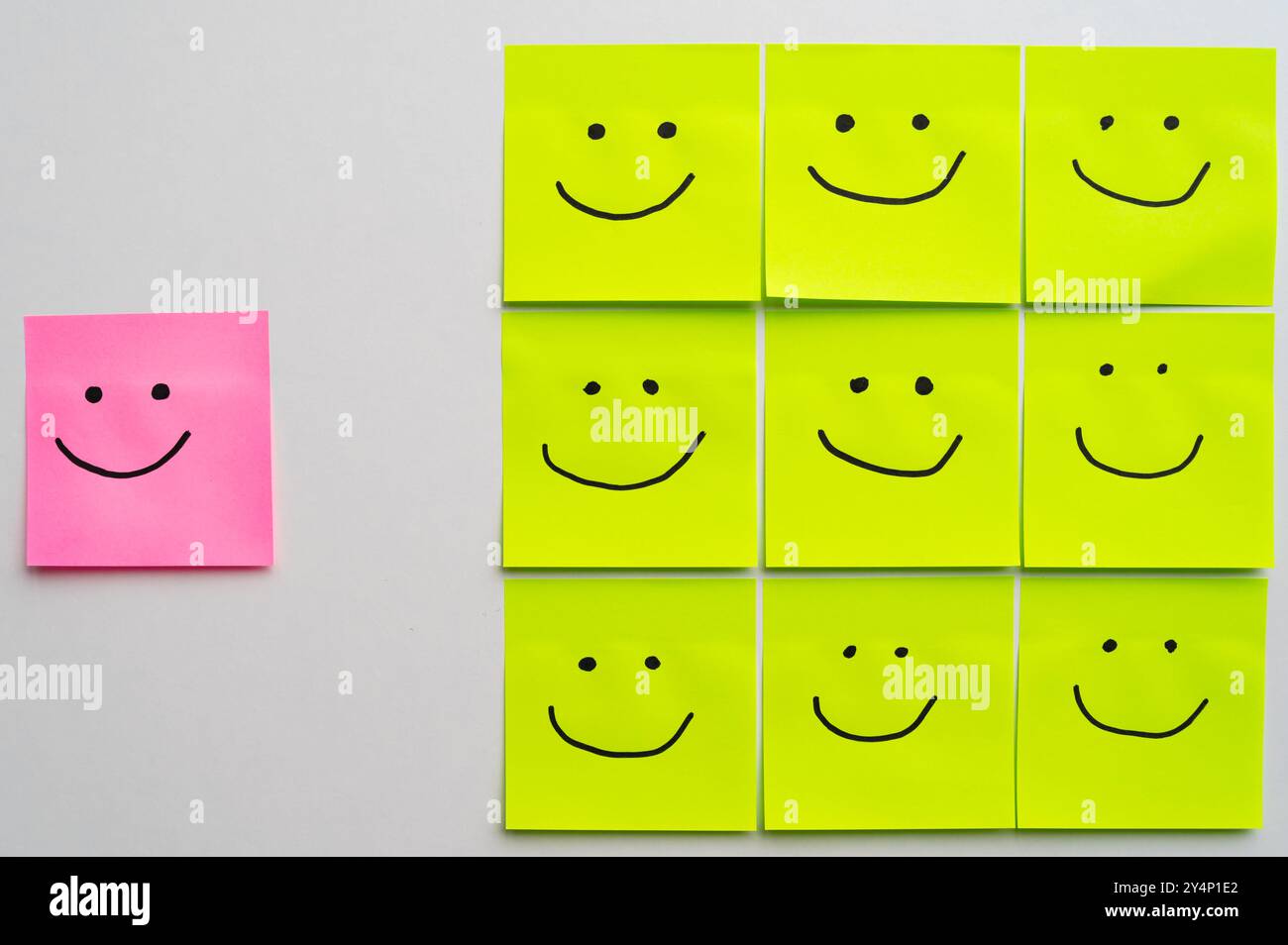 Colored sheets of paper, with smiley faces drawn on them, inclusion ...