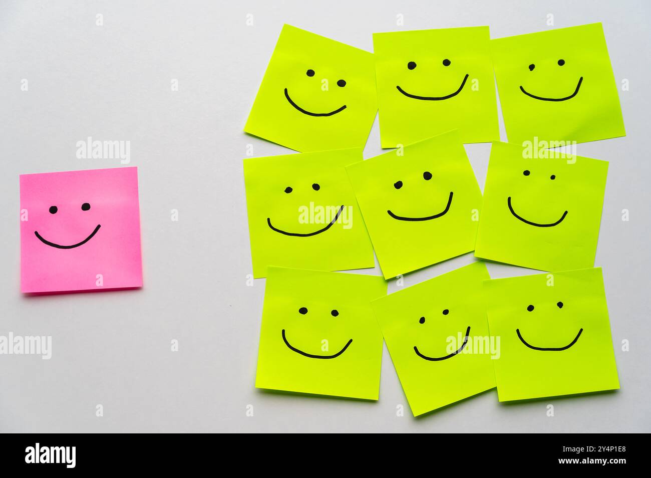 Colored sheets of paper, with smiley faces drawn on them, inclusion ...