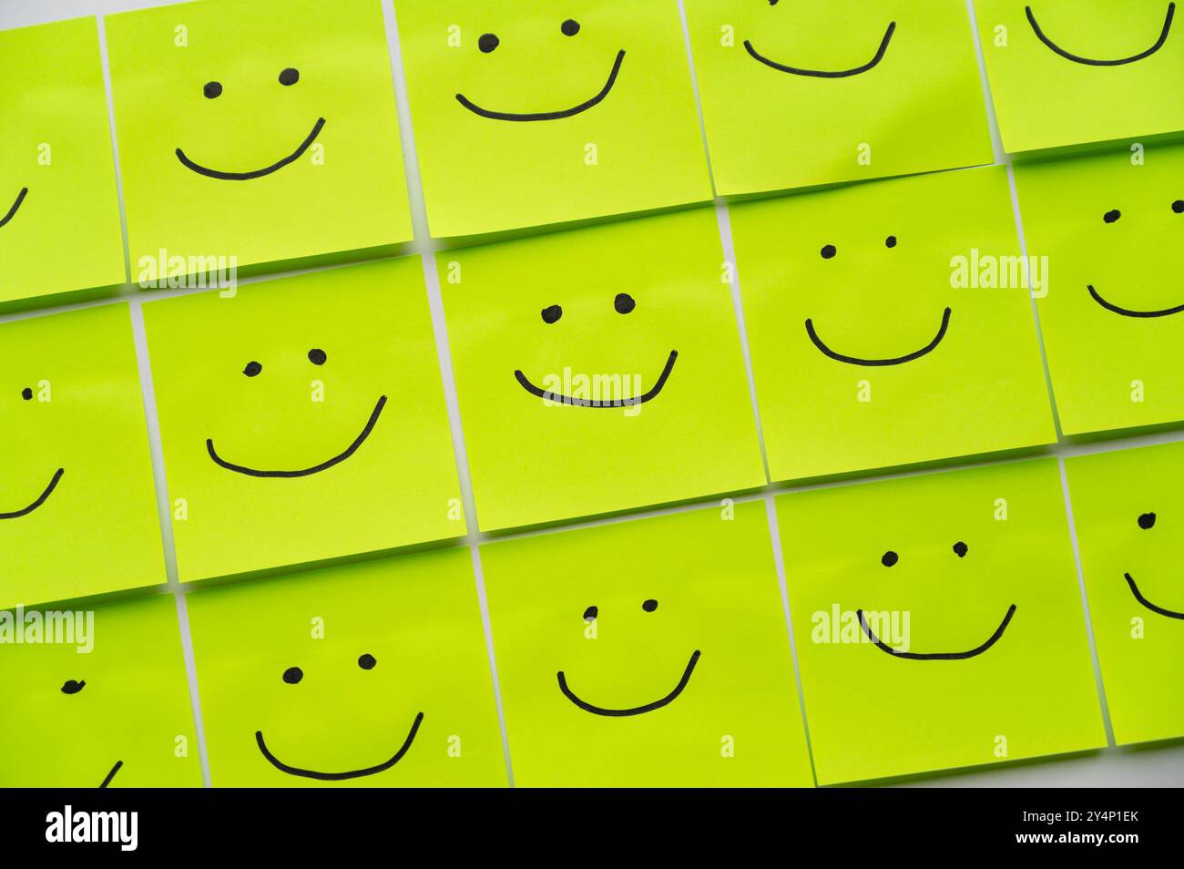 Colored sheets of paper, with smiley faces drawn on them, inclusion ...