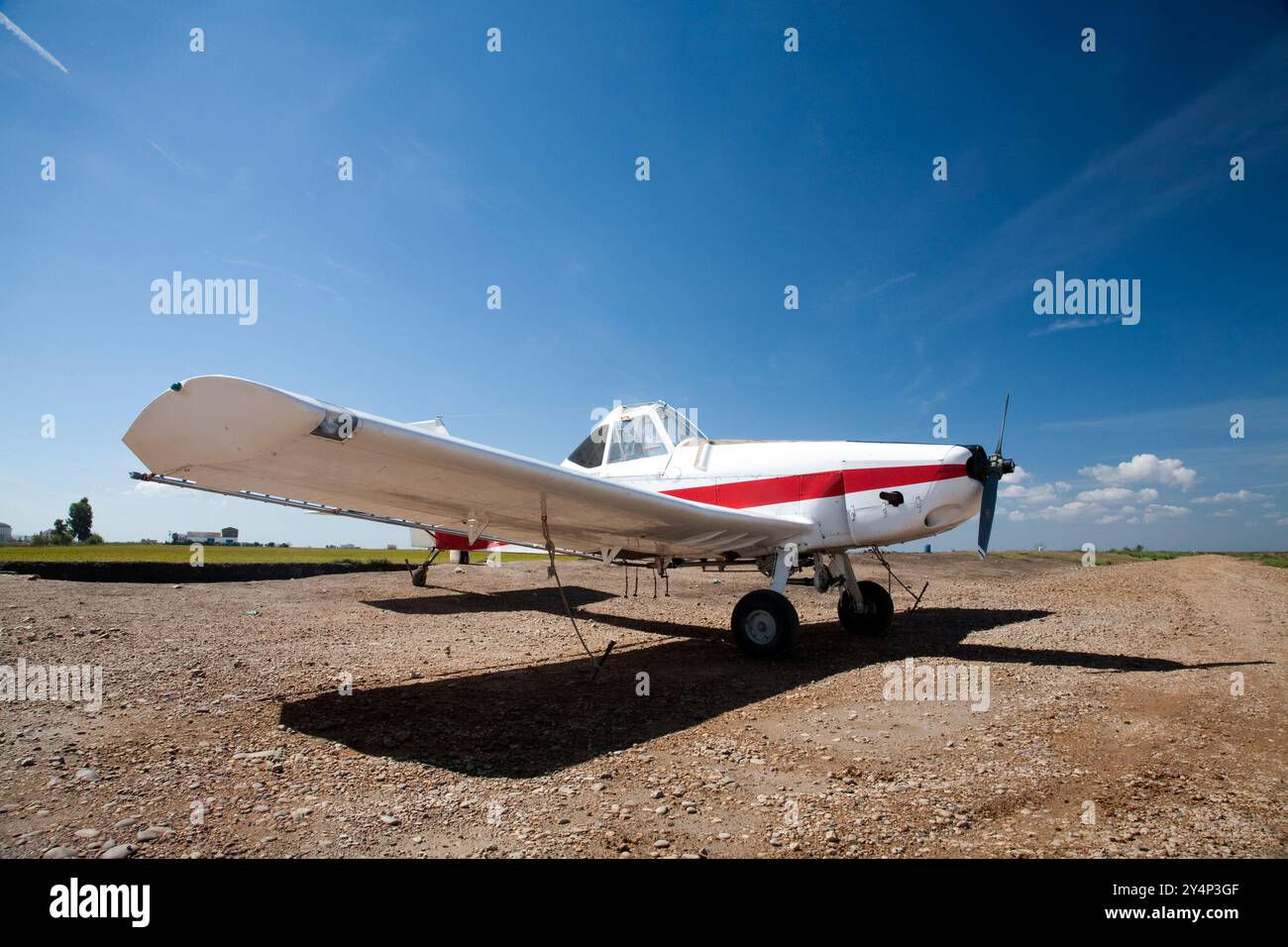 An agricultural plane stands prepared for seeding and crop spraying in ...